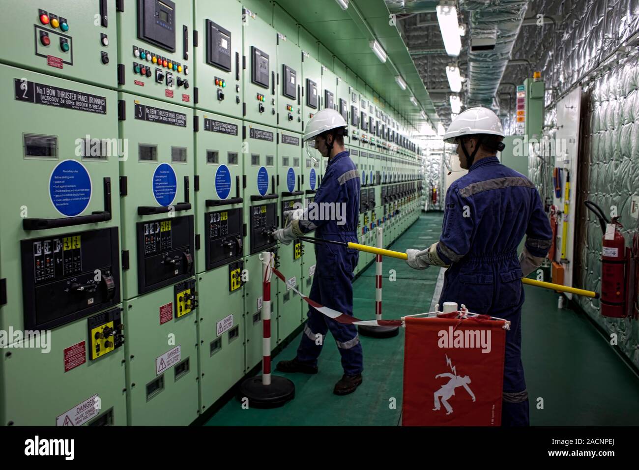 Amerigo Vespucci container ship. Workers inside the generator room of ...