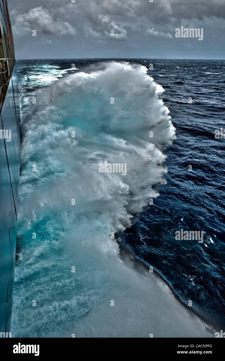 Container ship at sea. View of water lashing against the side of a ...