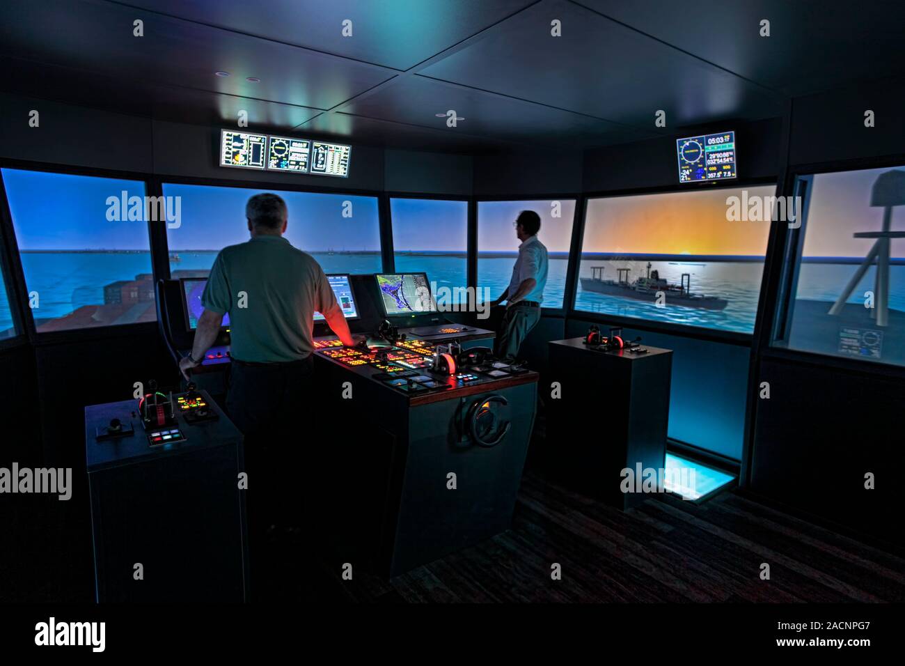 Container ship bridge simulator. Crew members training in a simulator ...