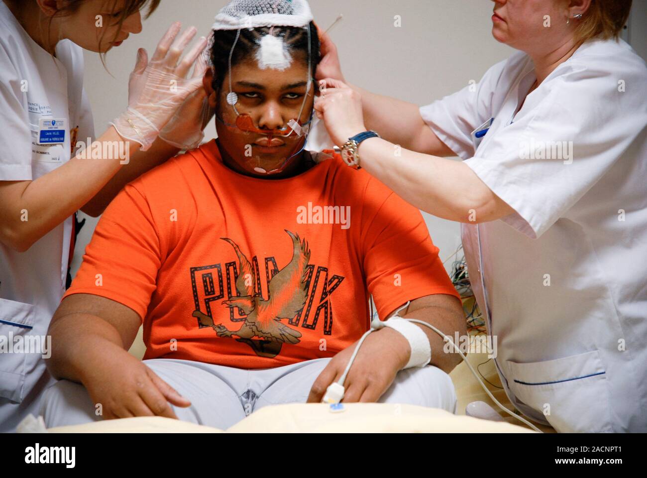Paediatric sleep study. Teenage boy with narcolepsy being prepared for ...