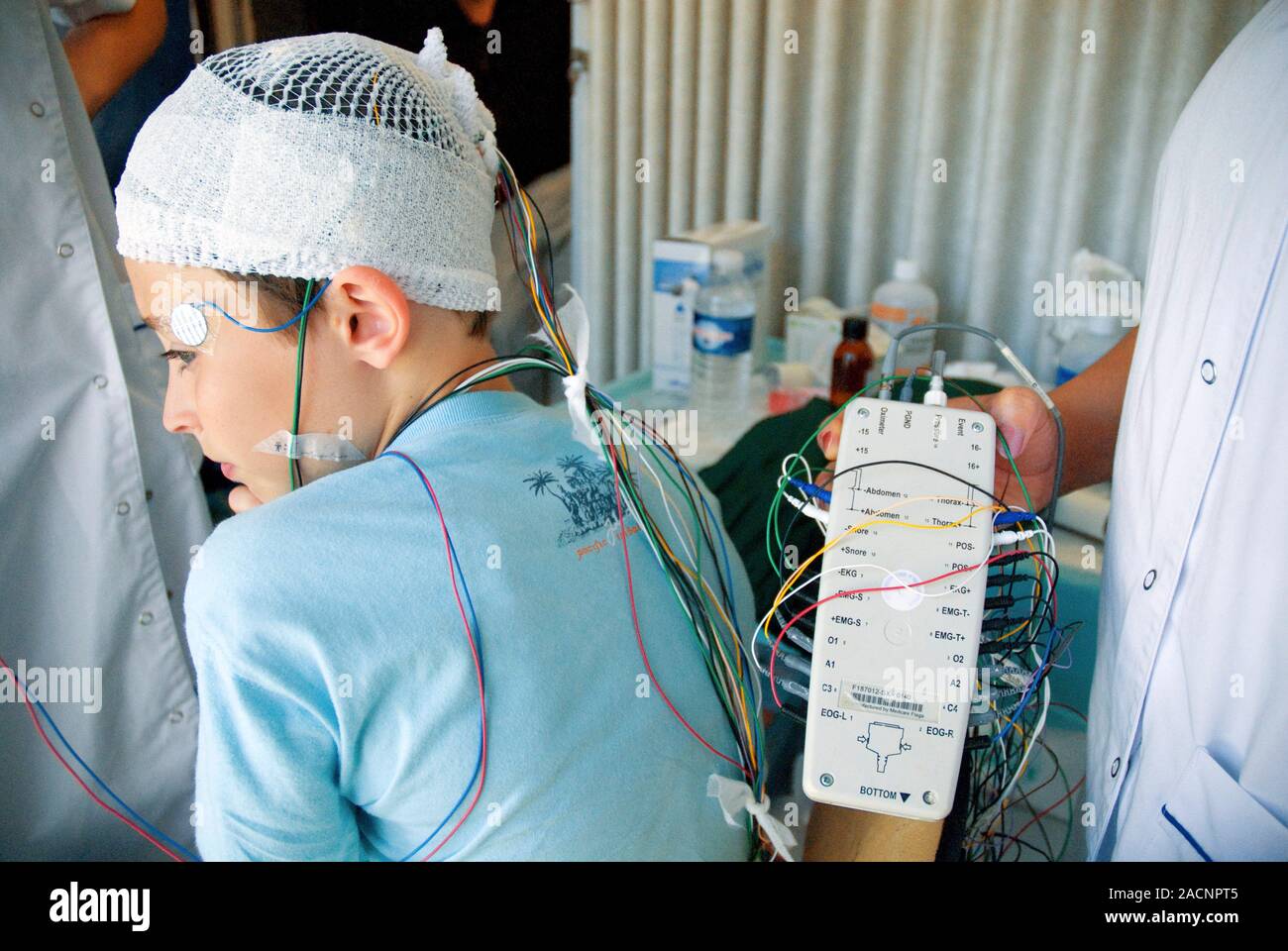Paediatric sleep study. Boy being prepared for a sleep study ...
