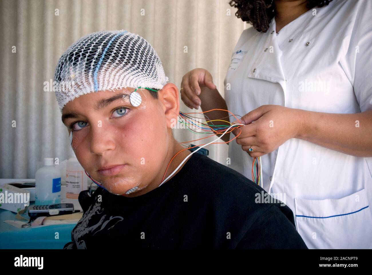 Paediatric sleep study. 11-year-old hyperactive boy being prepared for ...