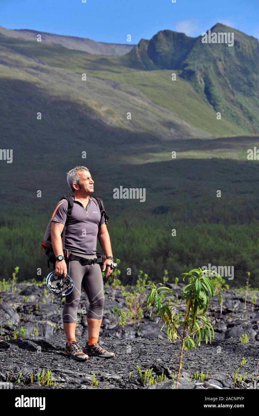 Lava cave exploration. Cave guide standing near the base of the Piton ...