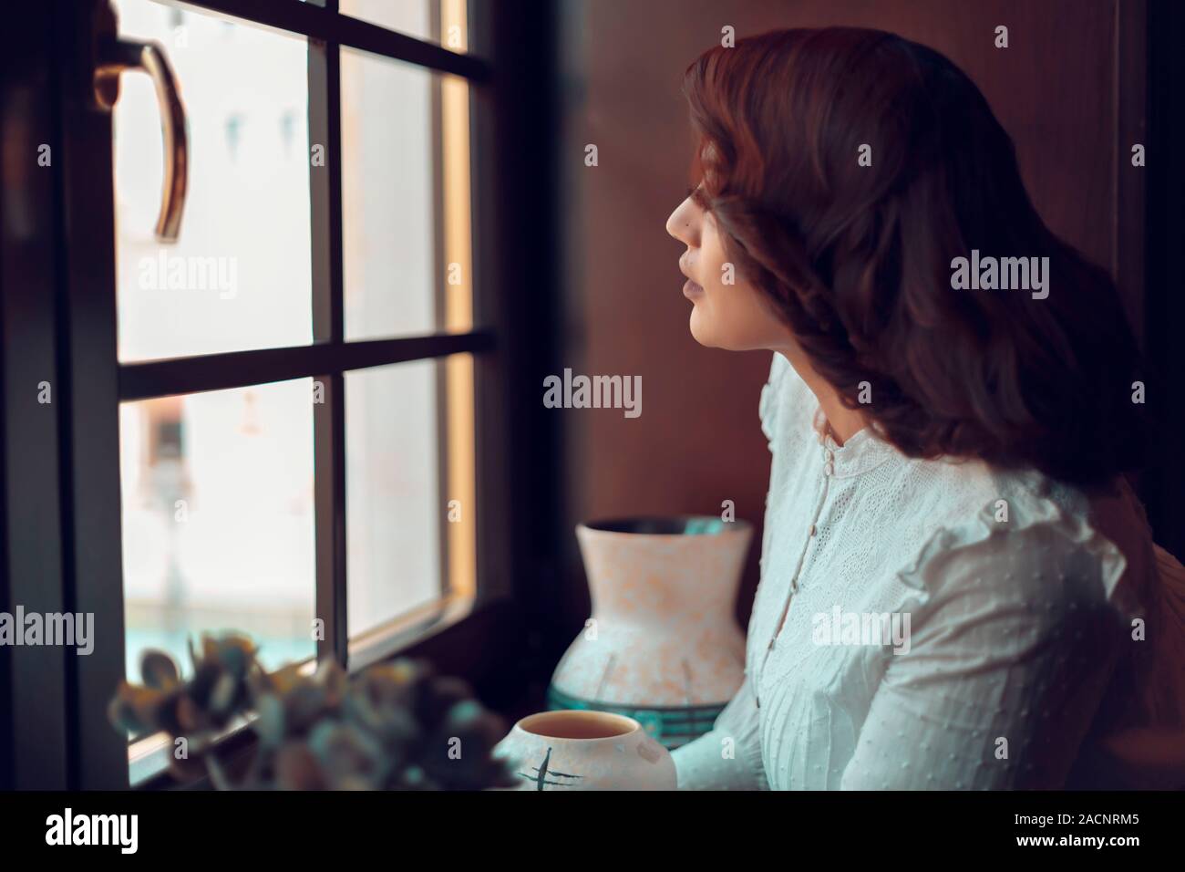 A Girl Looking Through Window Stock Photo - Alamy