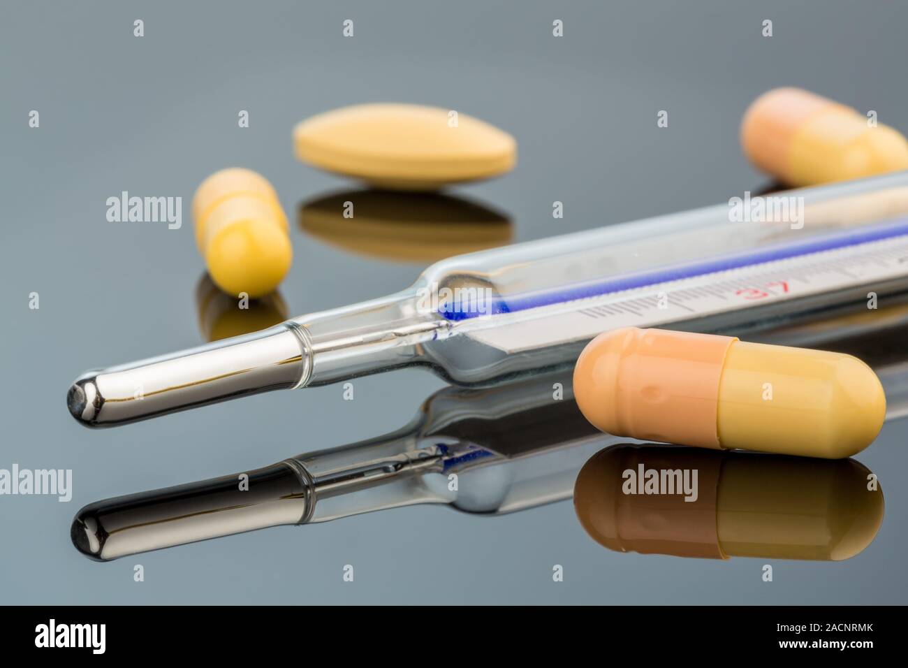 Fever thermometers and tablets Stock Photo - Alamy