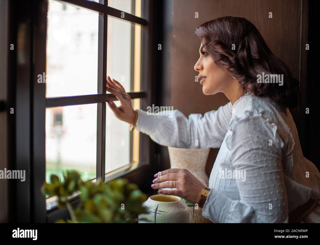 A Girl Looking Through Window Stock Photo - Alamy
