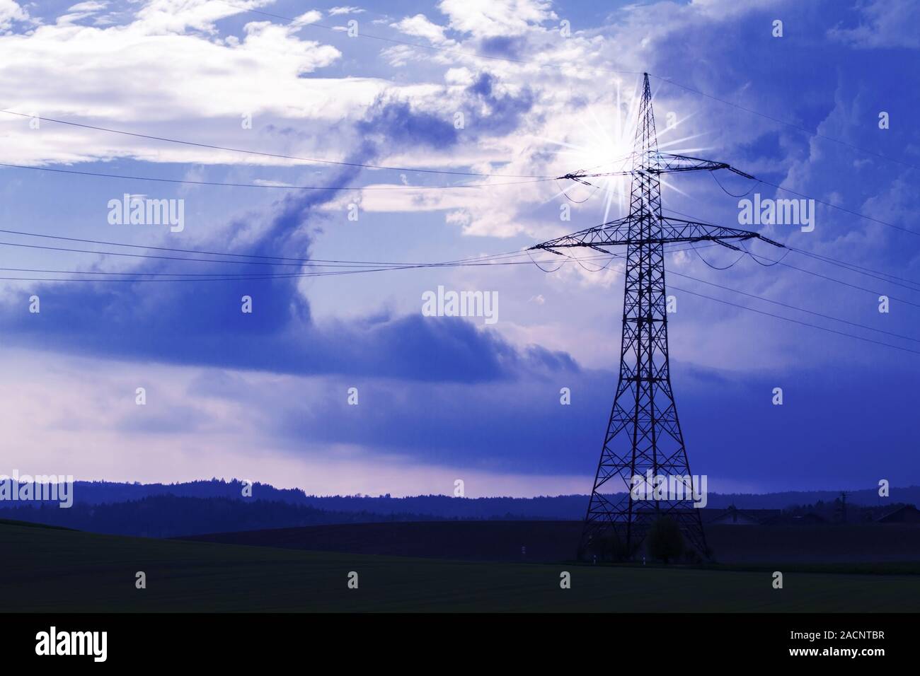 High-voltage pylon with solar rays Stock Photo - Alamy
