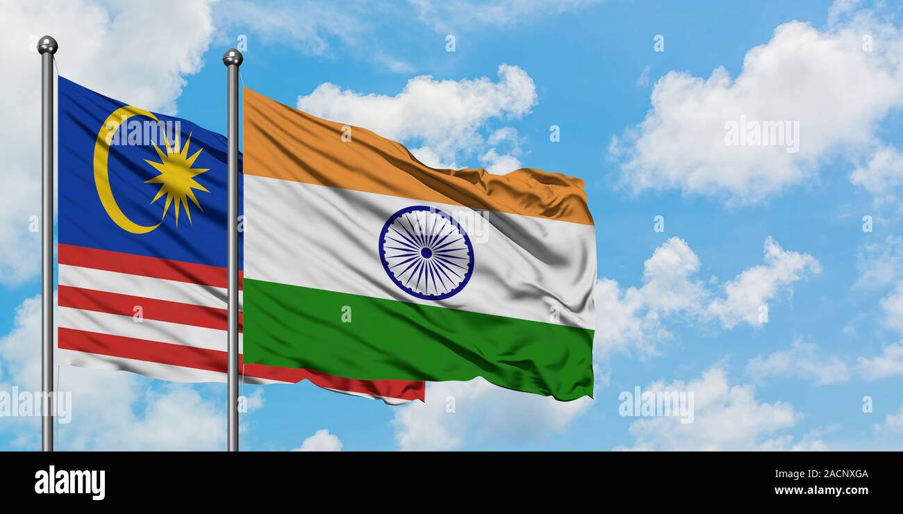 Malaysia and India flag waving in the wind against white cloudy blue ...