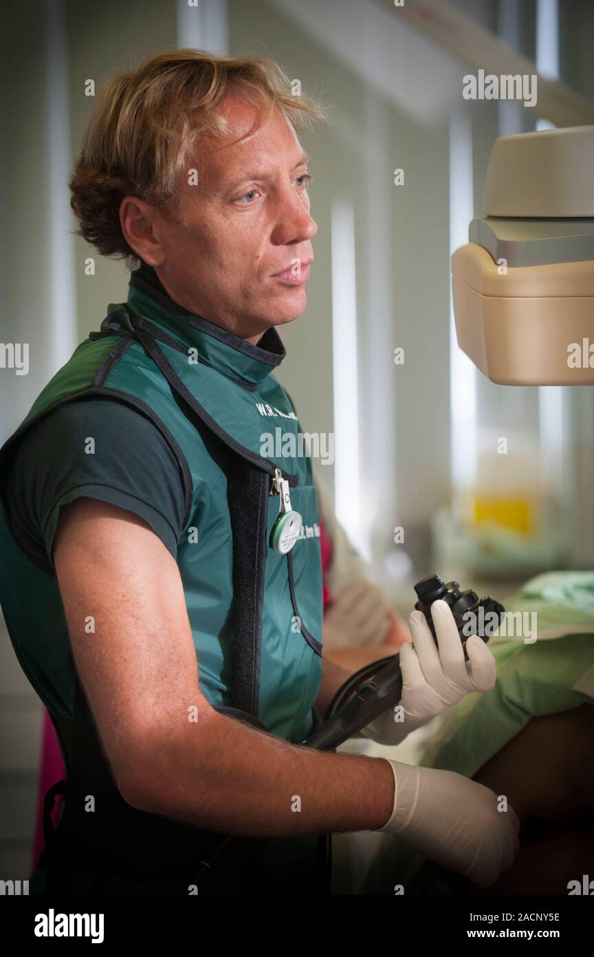 Colonoscopy. Doctor performing a colonoscopy on a patient. A ...