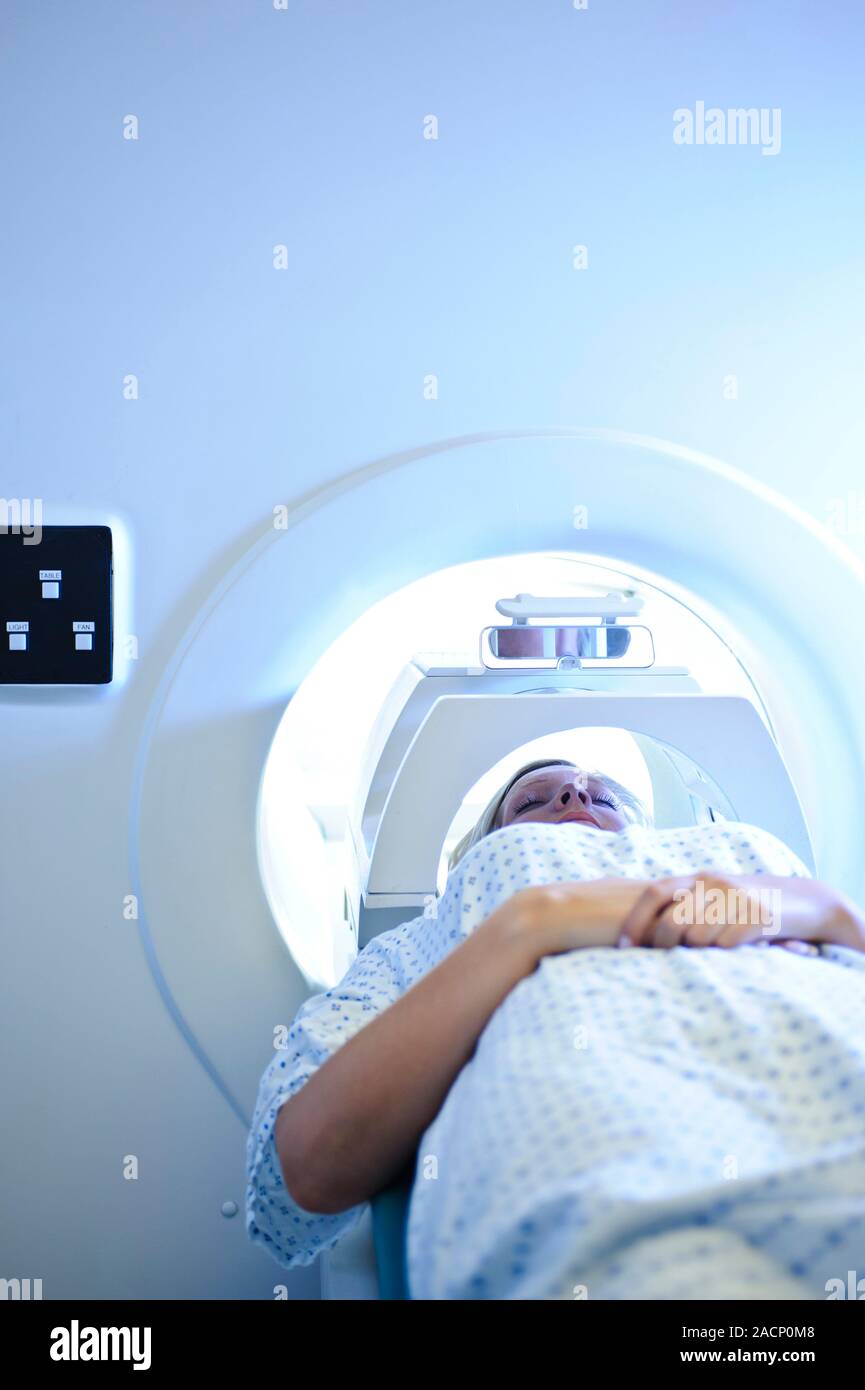 MRI scan. Female patient in an MRI (magnetic resonance imaging) scanner ...
