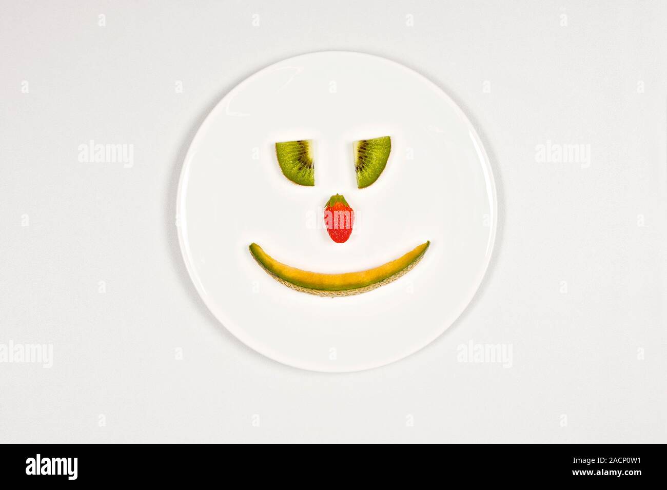 Happy food face. Food items arranged on a plate to represent a happy ...