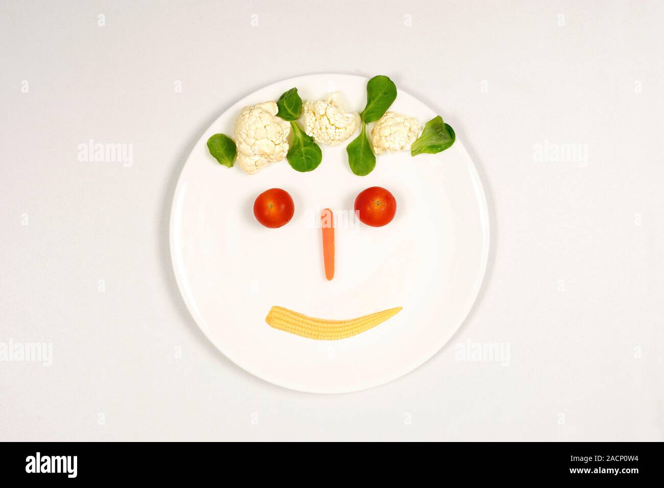 Happy food face. Food items arranged on a plate to represent a happy ...