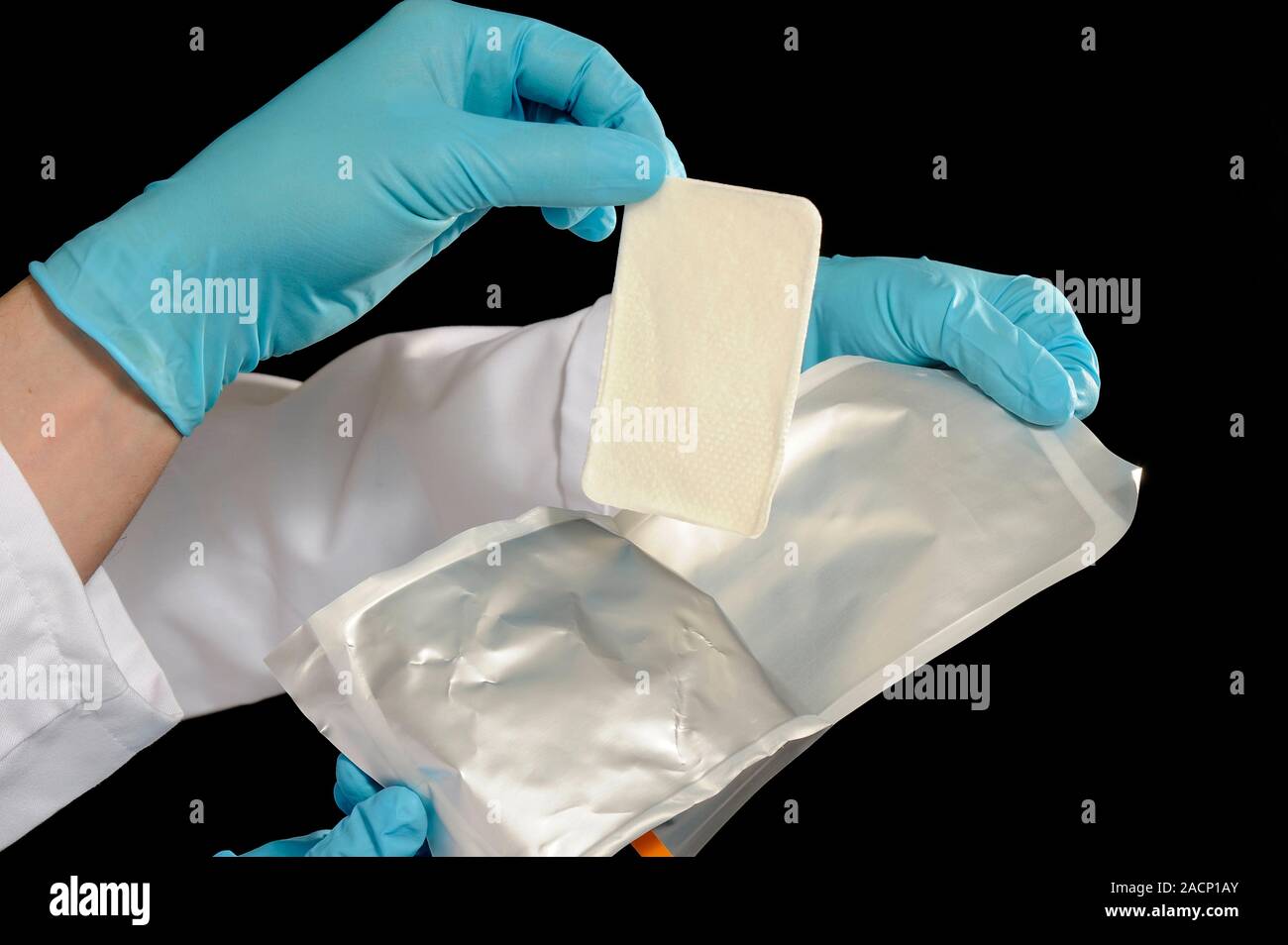 Biogel medical dressings. Technician holding a wound dressing made ...