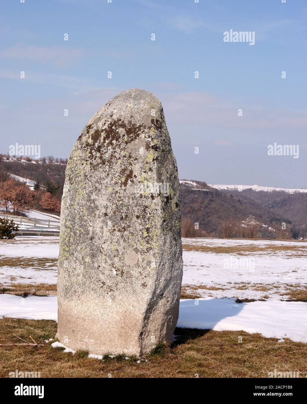Standing stone. Menhir (standing stone) on a snowy plain. Photographed ...