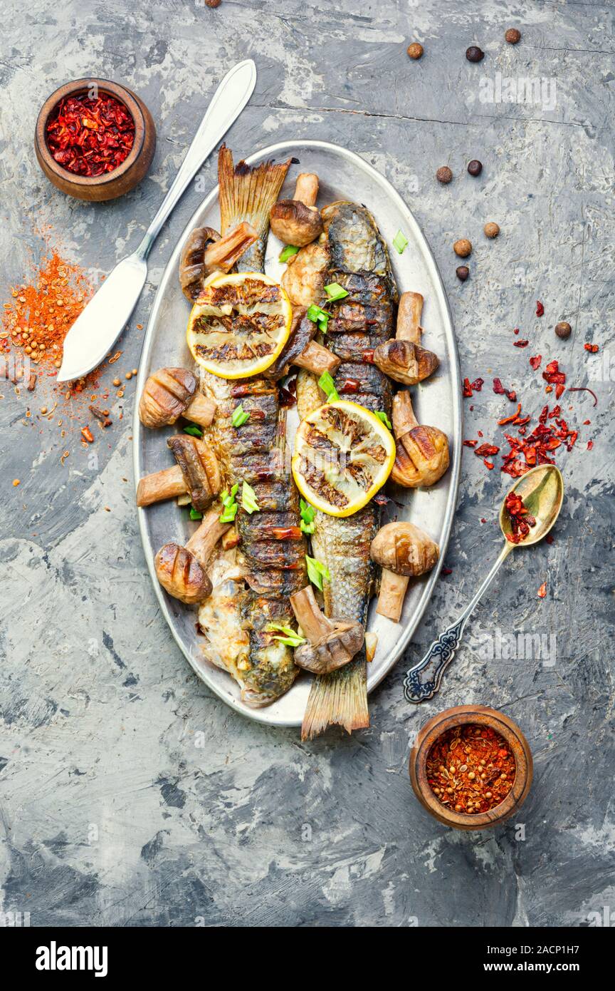 Baked whole pelengas fish with mushrooms and lemon.Sea food.Grilled ...