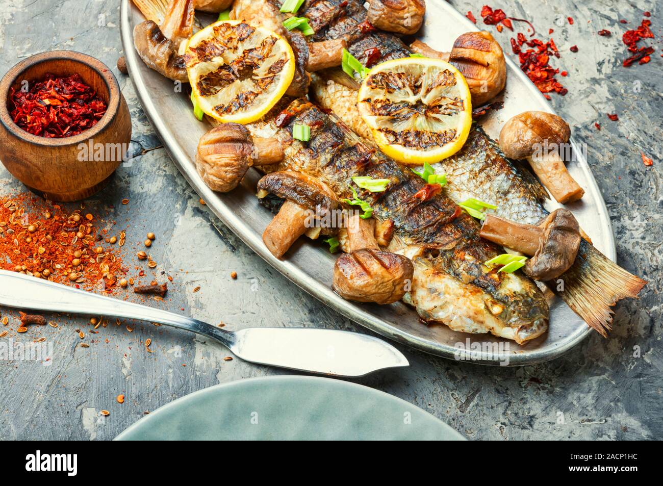 Roasted pelengas fish with mushrooms and lemon.Sea food.Grilled fish ...