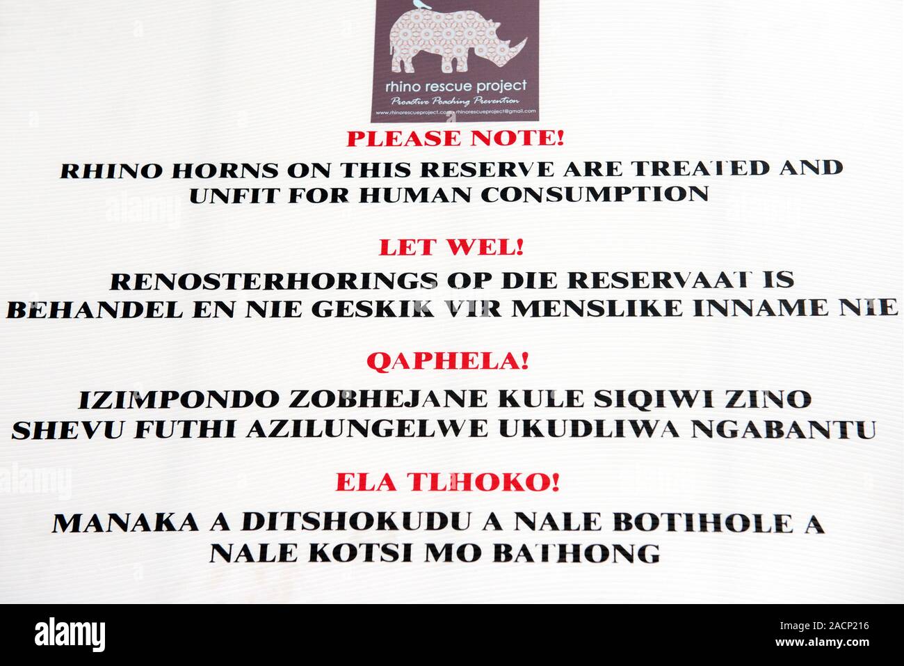 Rhinoceros poaching notice. This deterrent notice on the outside fences of a game reserve warns ...