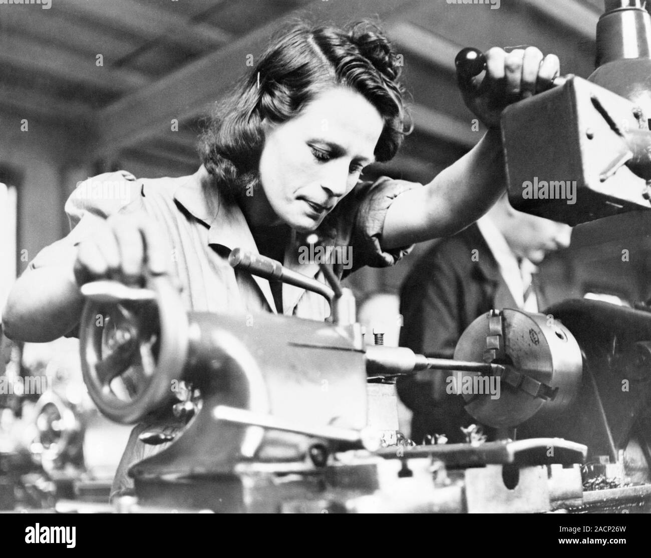 Machine gun production, World War II. Irish female worker using a lathe ...
