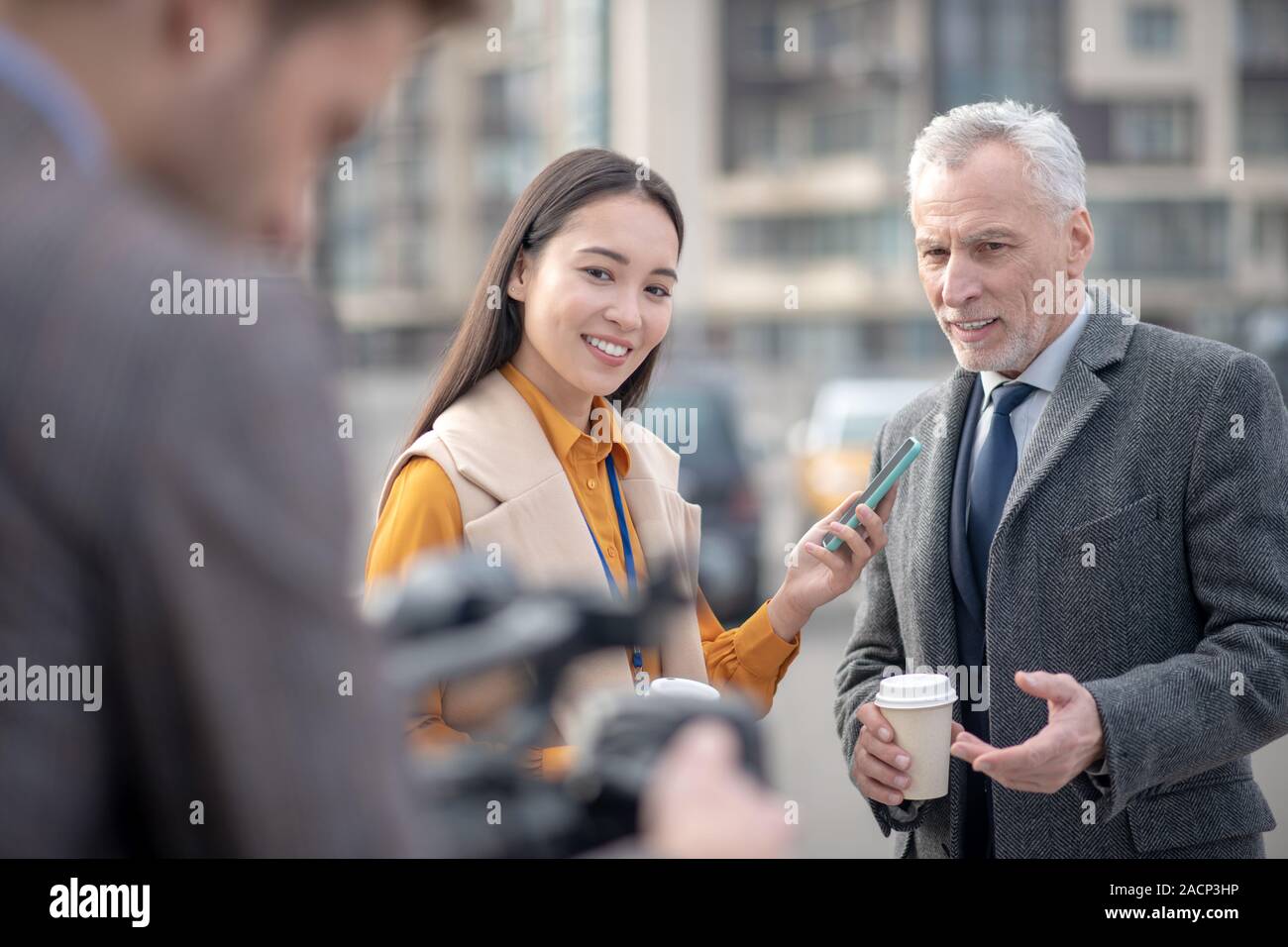 Reporter making street interview hi-res stock photography and images ...
