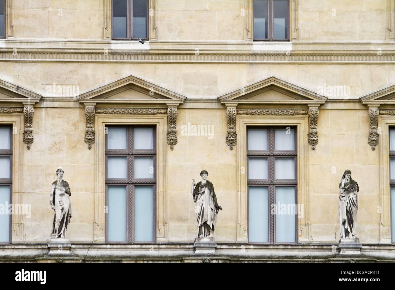 beautiful statues located on the Museum of the Louvre in Paris, France ...