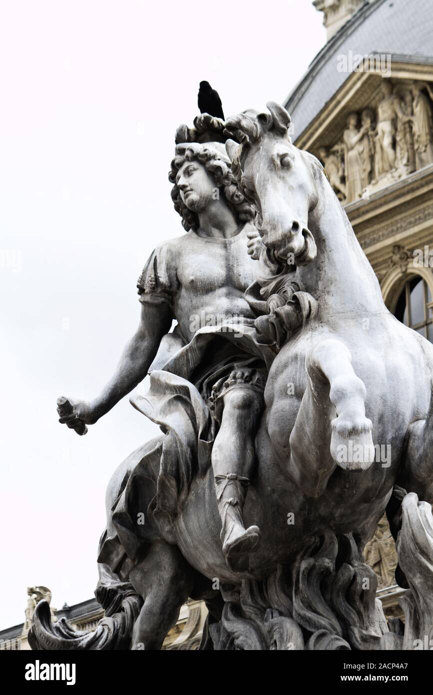 beautiful statues located on the Museum of the Louvre in Paris, France ...