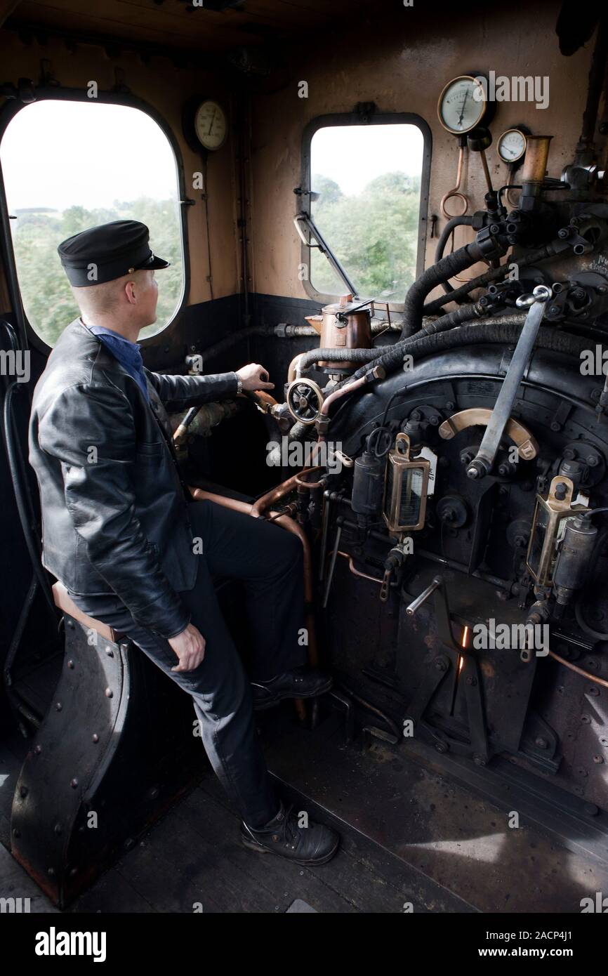 Steam locomotive driver. Museum volunteer driving steam locomotive K563 ...