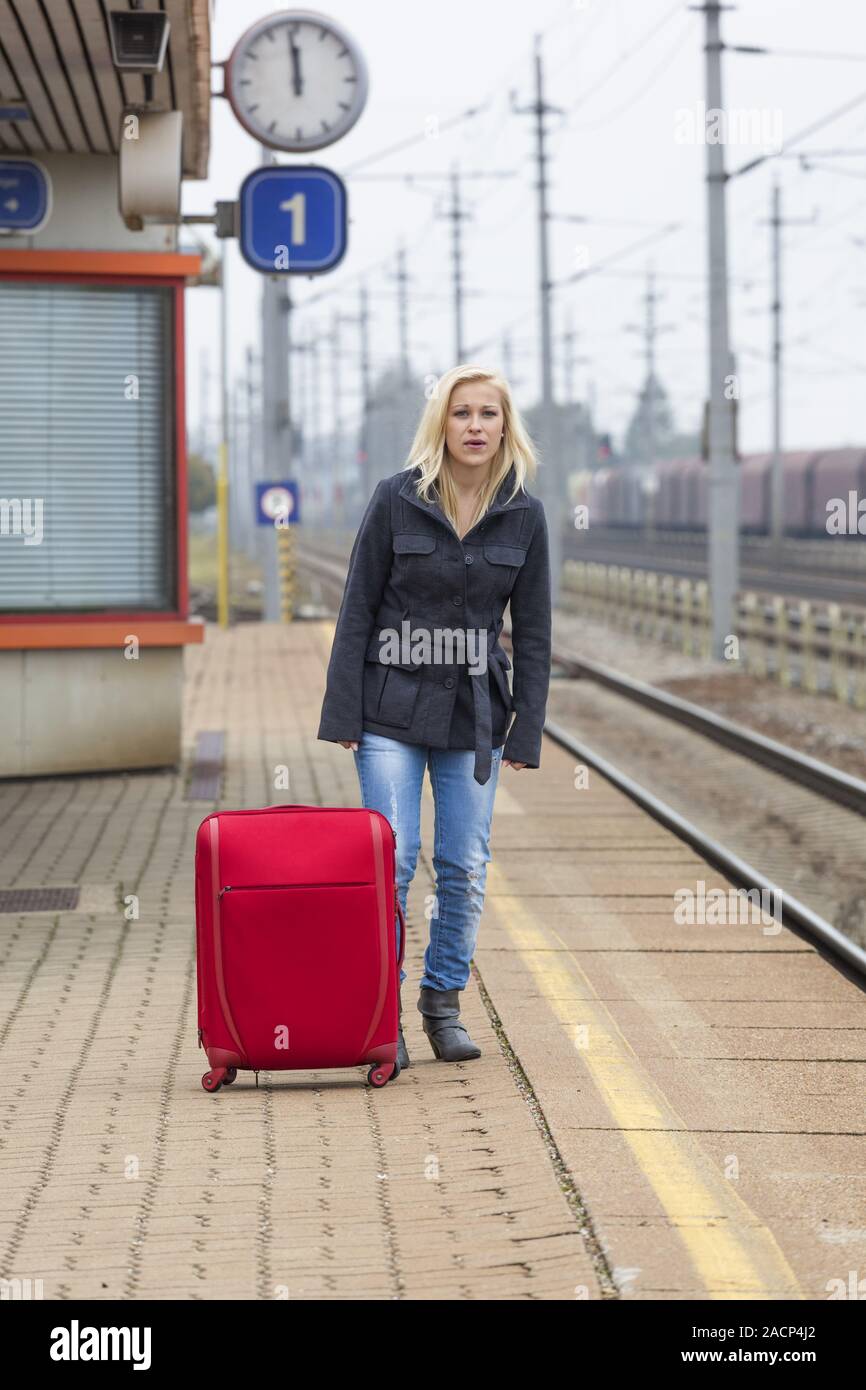 Woman waiting at train station hi-res stock photography and images - Alamy