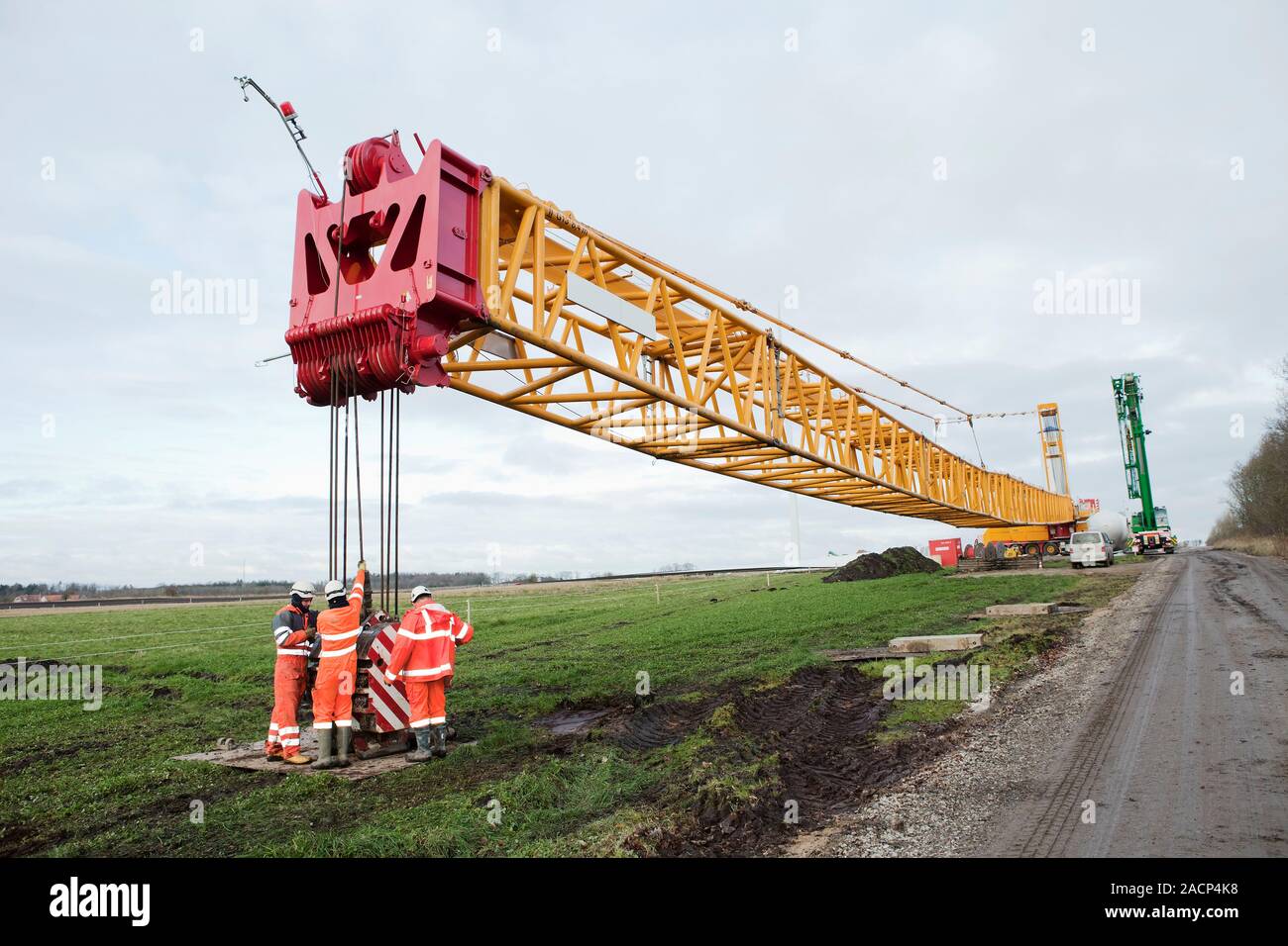 Wind turbine assembly. Industrial workers preparing a crane to be used ...