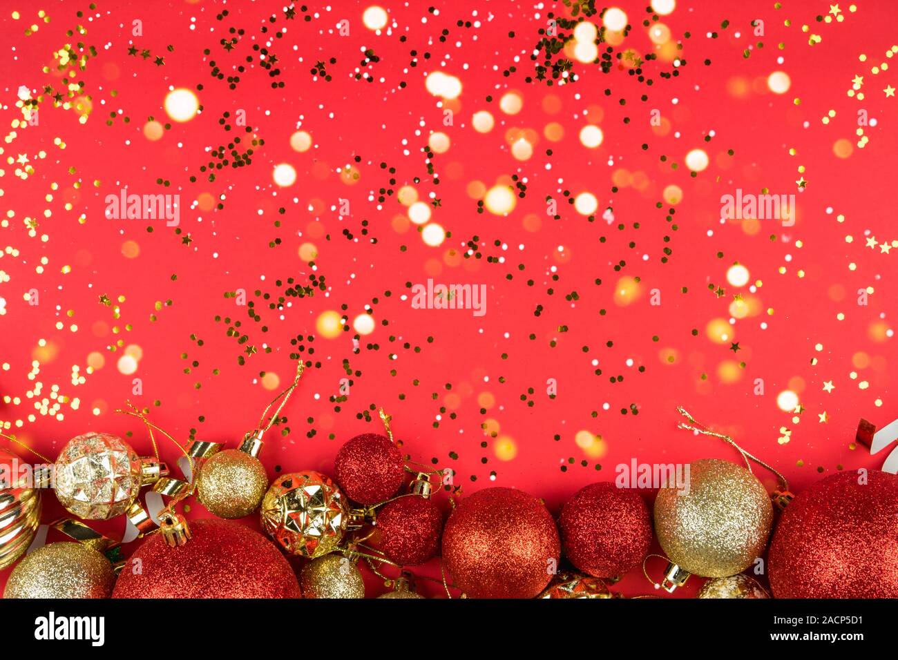 Festive background with lights and snow falling on a scattering of toys ...