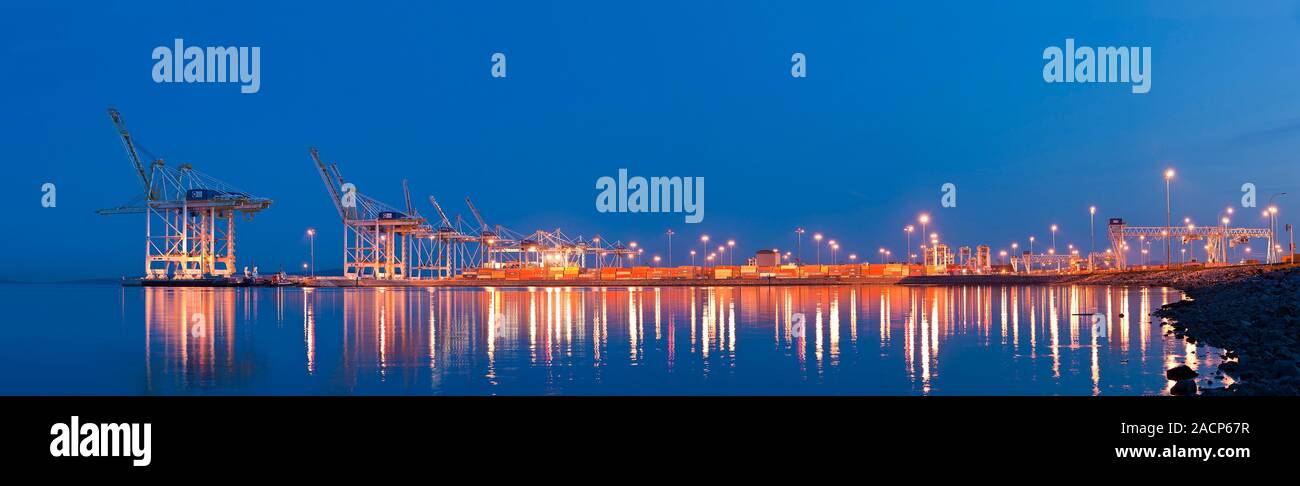 Container port. Lights of a container port reflected in water. Rows of ...