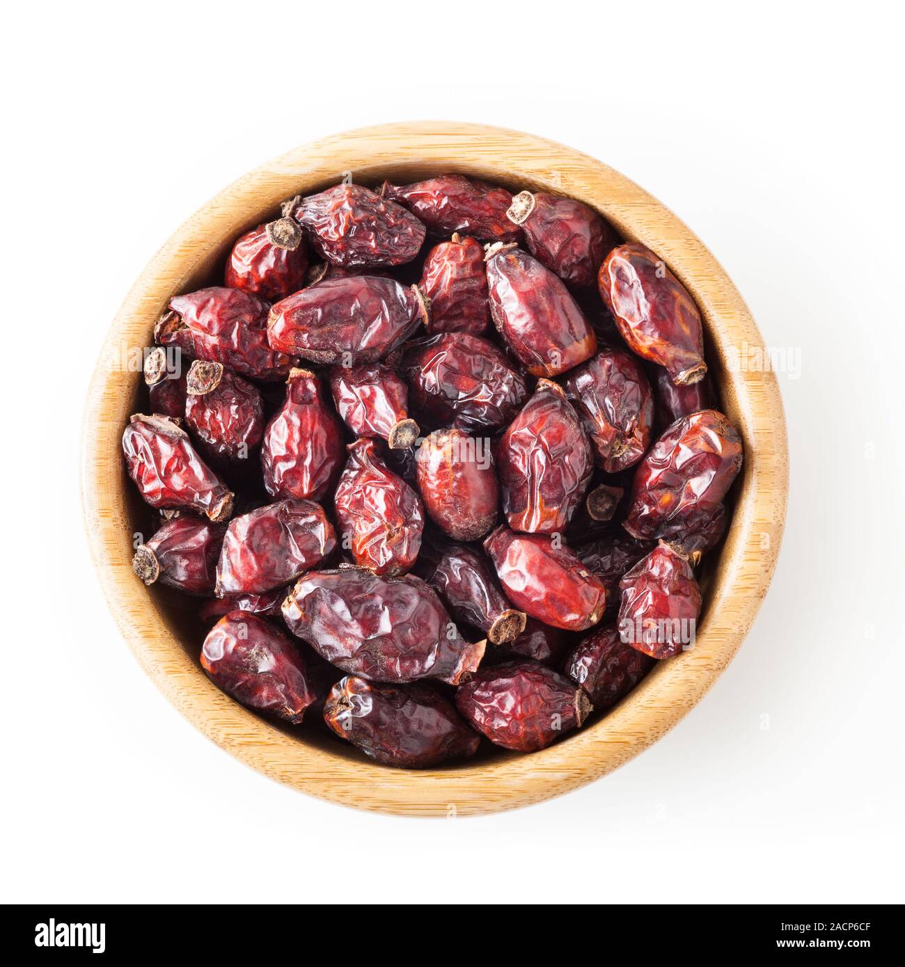 Dried wild rose berries in wooden bowl isolated on white background ...
