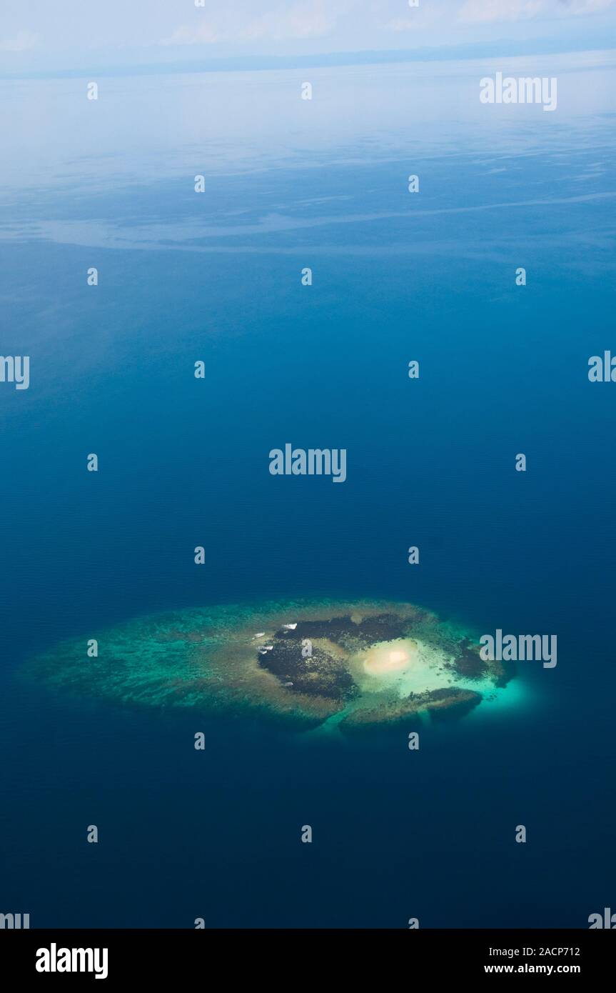 Aerial veiw of tropical shallow atoll reef taken from an airplane above ...