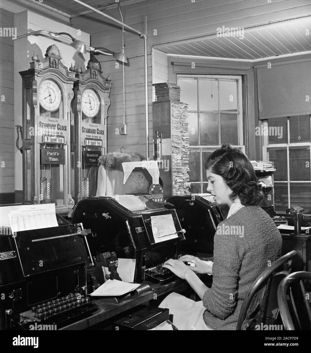 Teletype operator in the telegraph office of the Atchison, Topeka and Santa Fe Railroad, USA ...