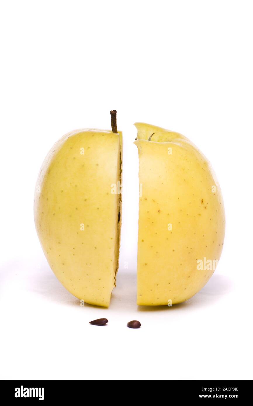 yellow apple sliced in half on white Stock Photo - Alamy