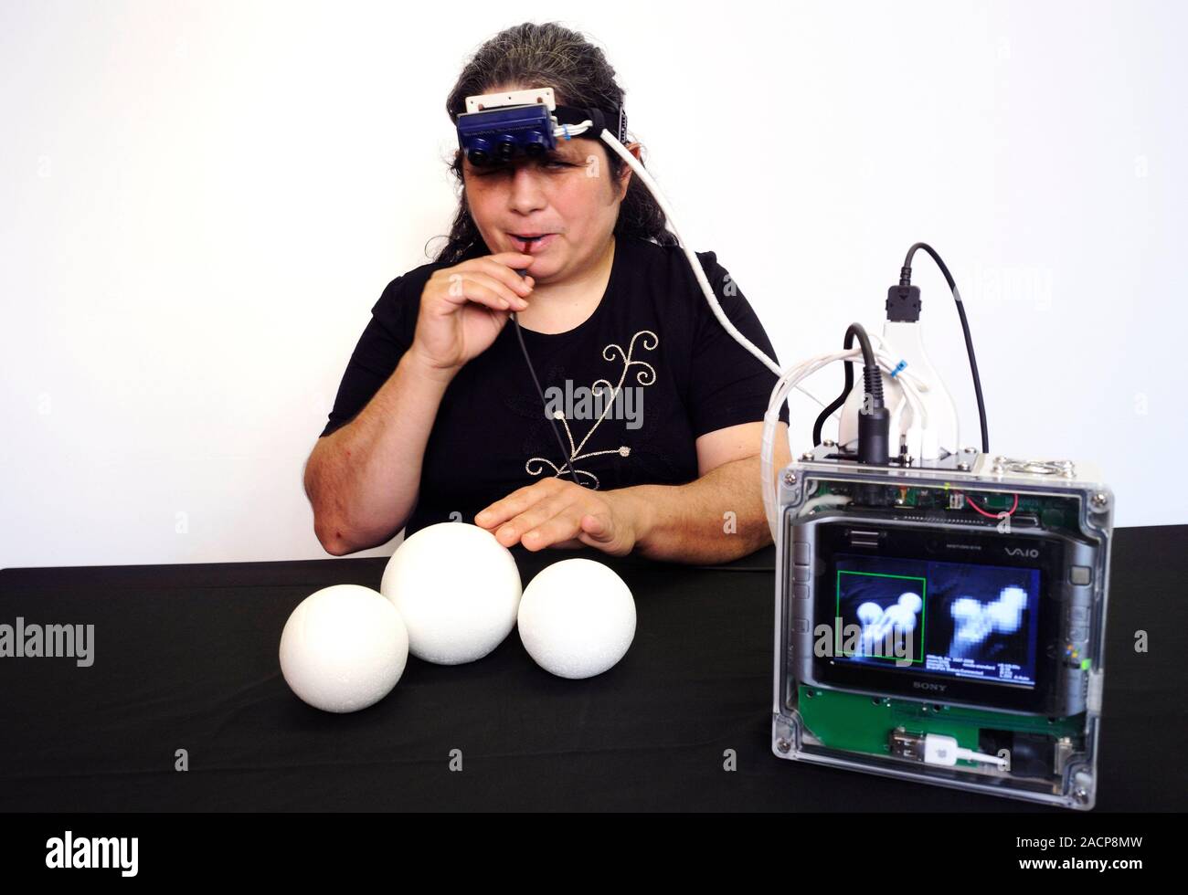 Tongue visual aid Blind woman testing a device that allows her to ...