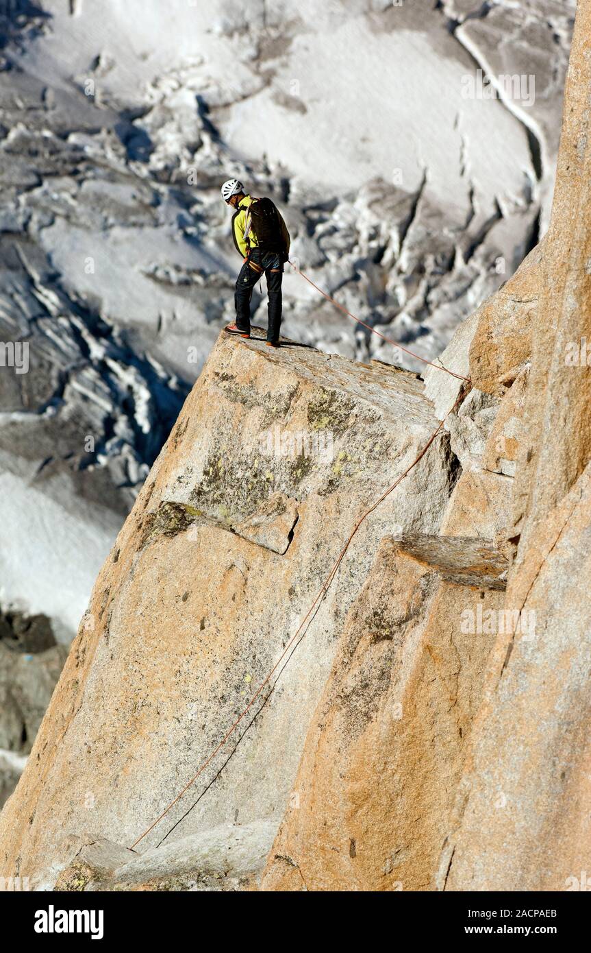 Mountaineering in the French Alps. Mountaineer climbing a granite rock ...