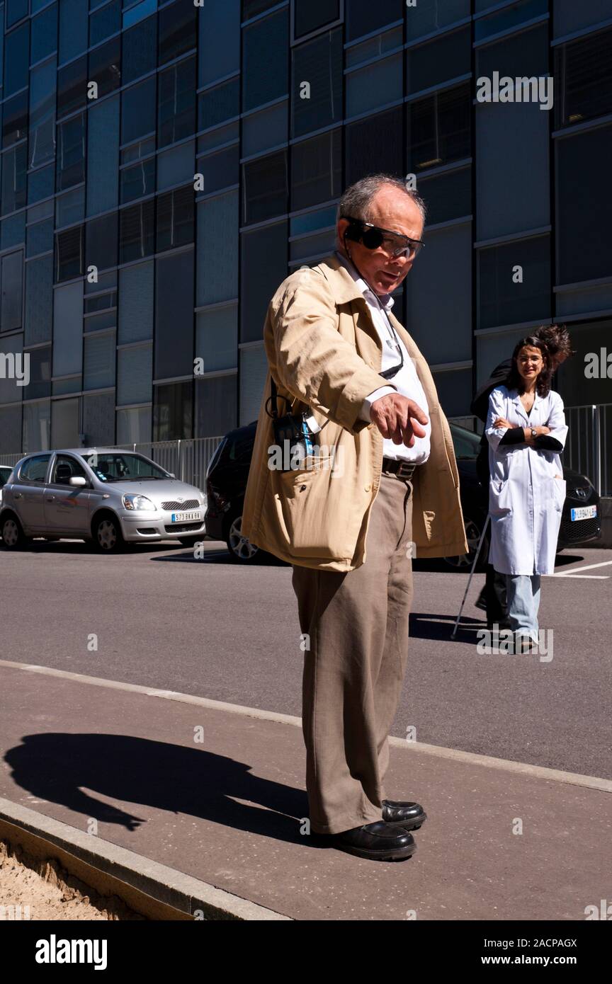 Argus II artificial retina patient walking outdoors with an ...
