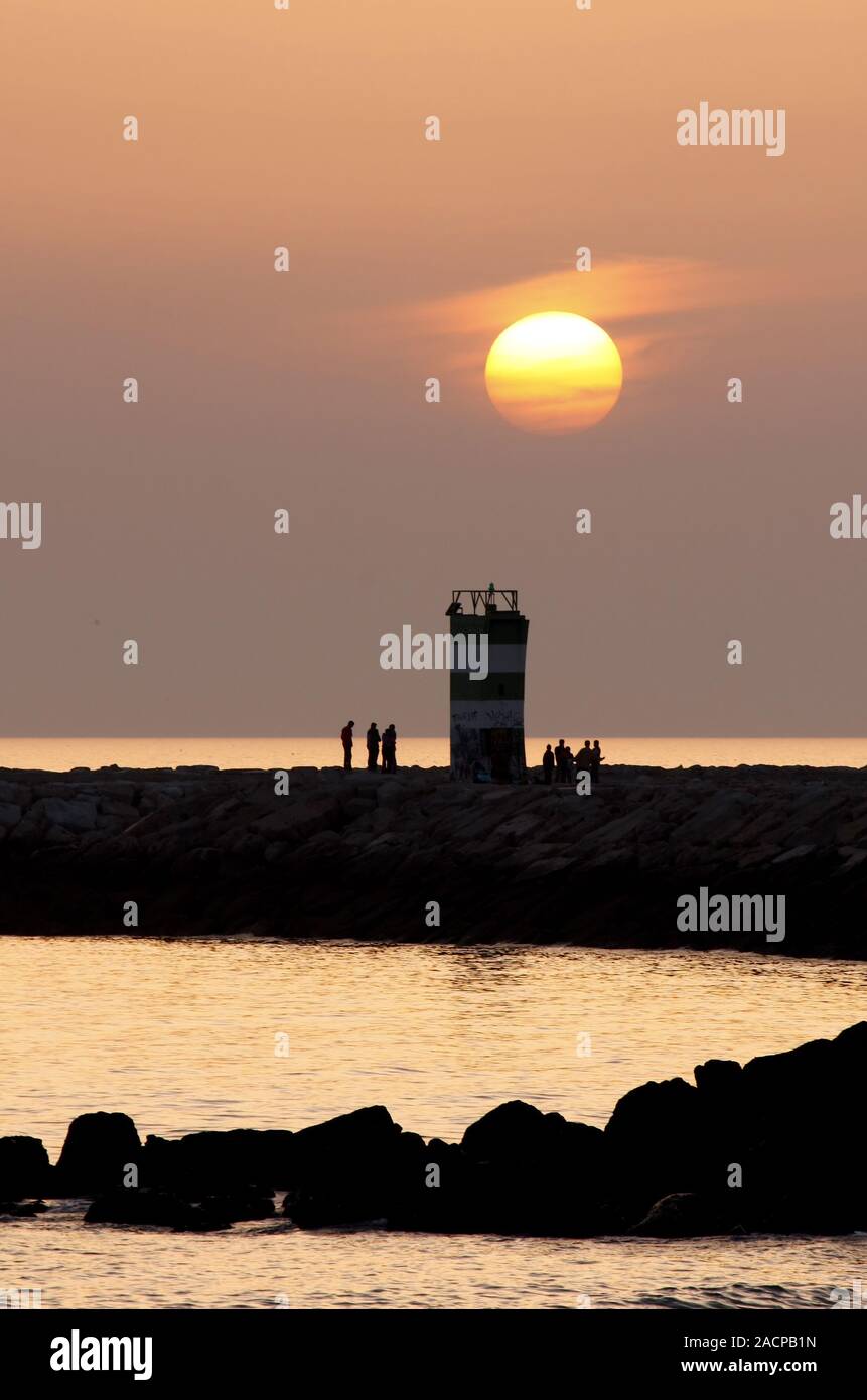 People on the peer at sunset Stock Photo - Alamy