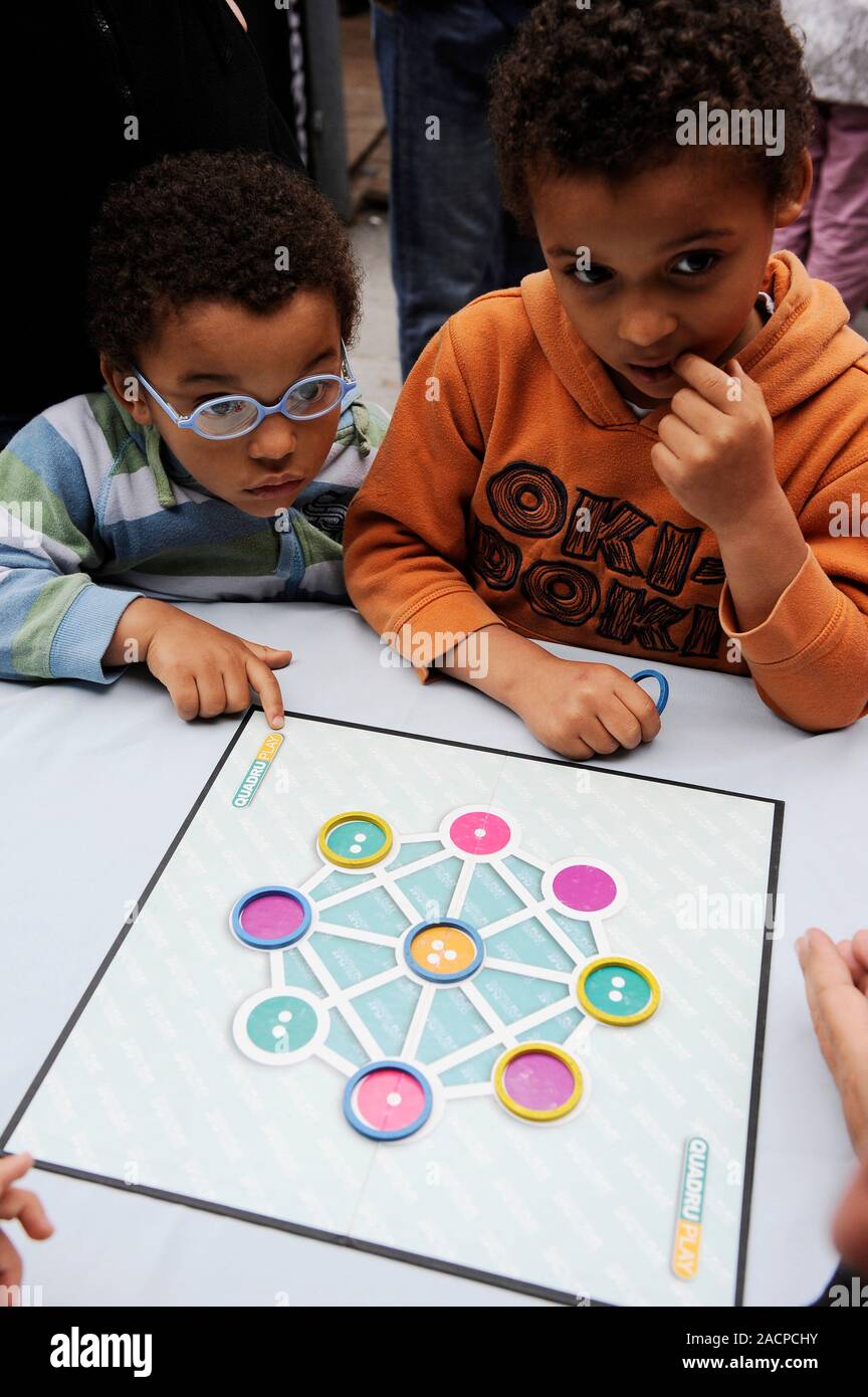Games and culture exhibition. Children playing a game at the 11th Salon ...