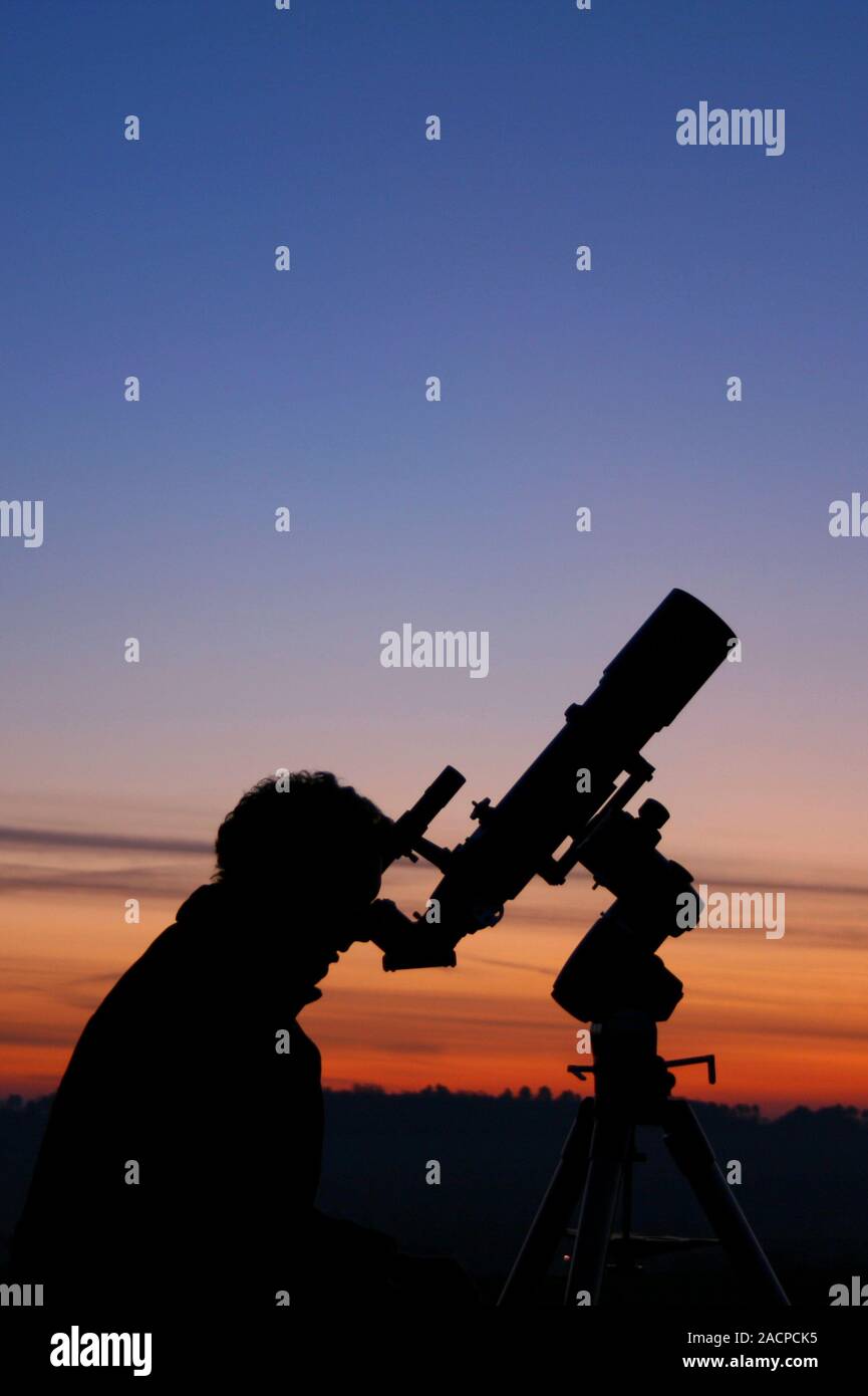 Astronomer using a telescope Stock Photo - Alamy