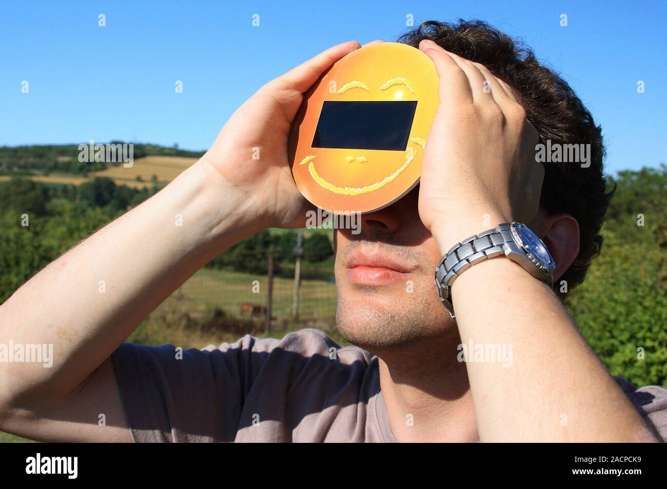 Man observing a solar eclipse Stock Photo - Alamy