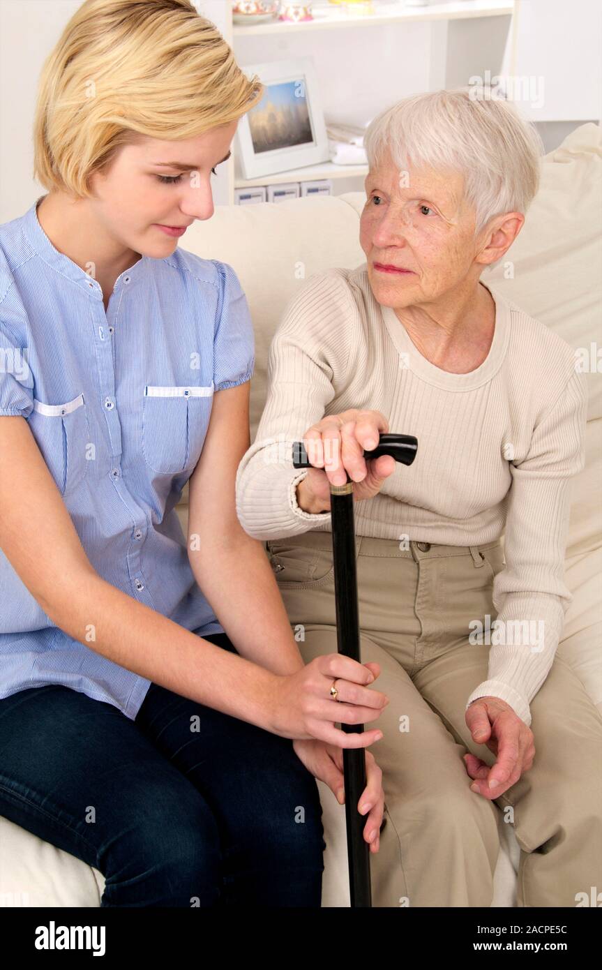 Elderly woman and carer. Woman caring for an 82-year-old woman who is ...
