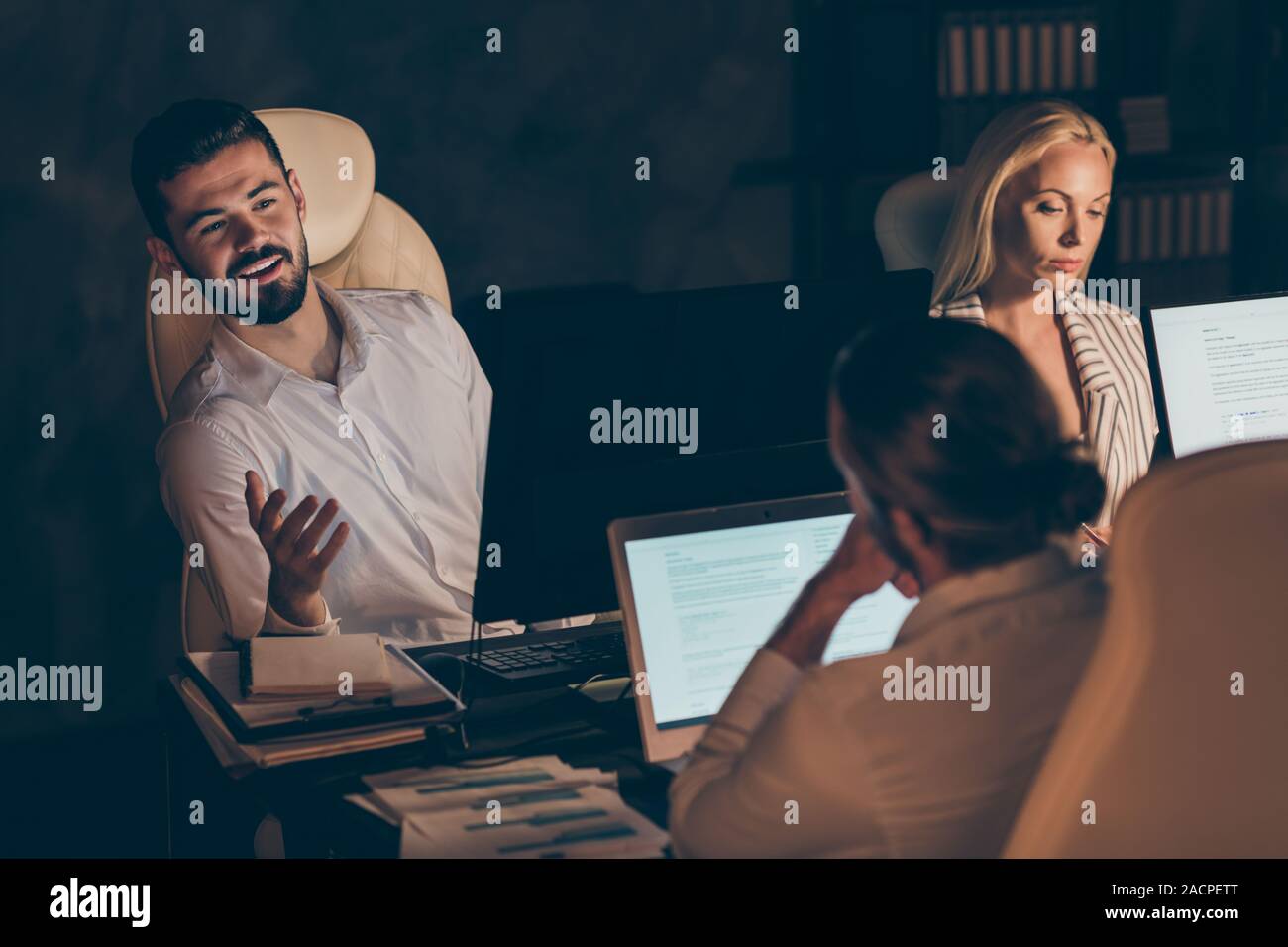 Nice attractive cheerful hardworking focused guy coworkers writing code ...