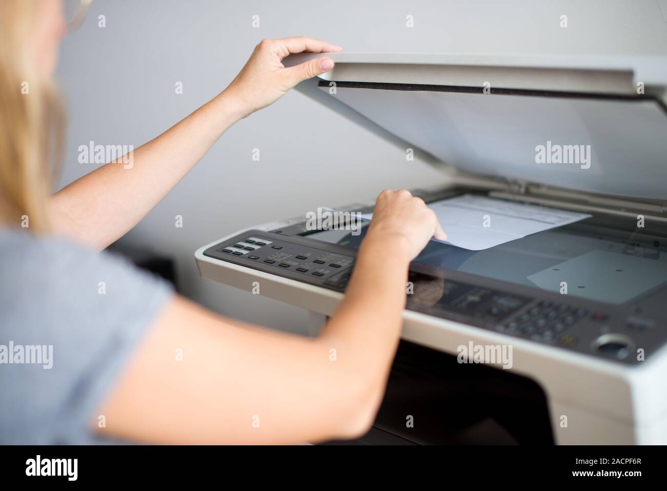Close-up on the hands of a woman doing photocopies in the office. Woman ...