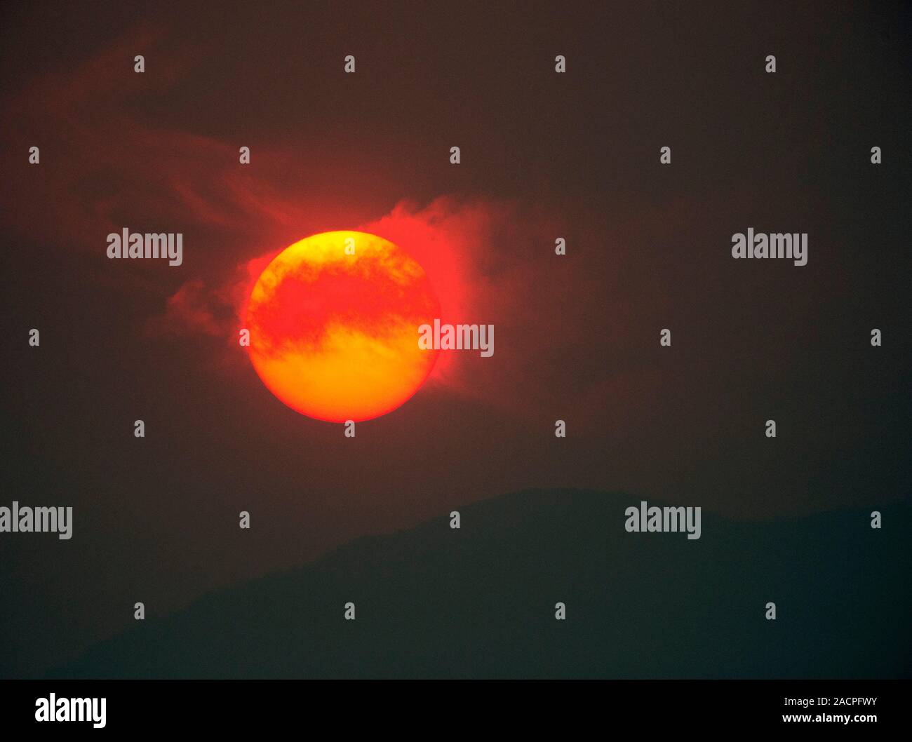 Sun setting behind smoke from bushfires. Photographed at Mana Pools ...