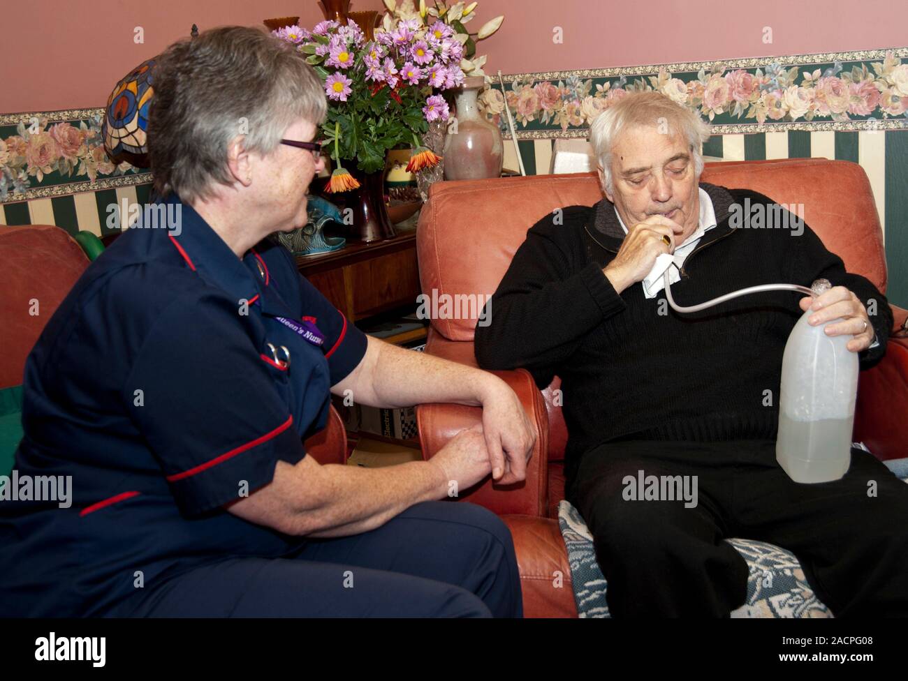 Community nursing. Advanced community nurse practitioner helping a 73 ...