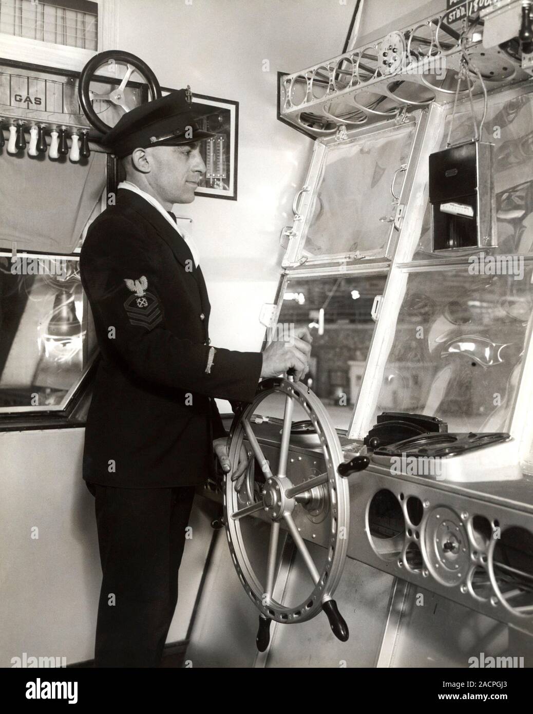 Airship control car. Pilot at the wheel in the control car of the USS ...