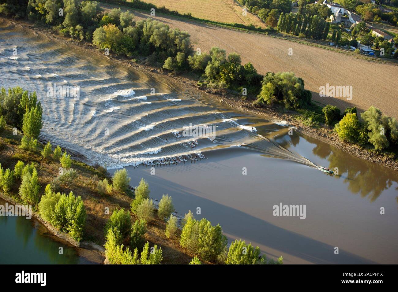 Surfers on the Garonne tidal bore, aerial photograph. Caused by the ...