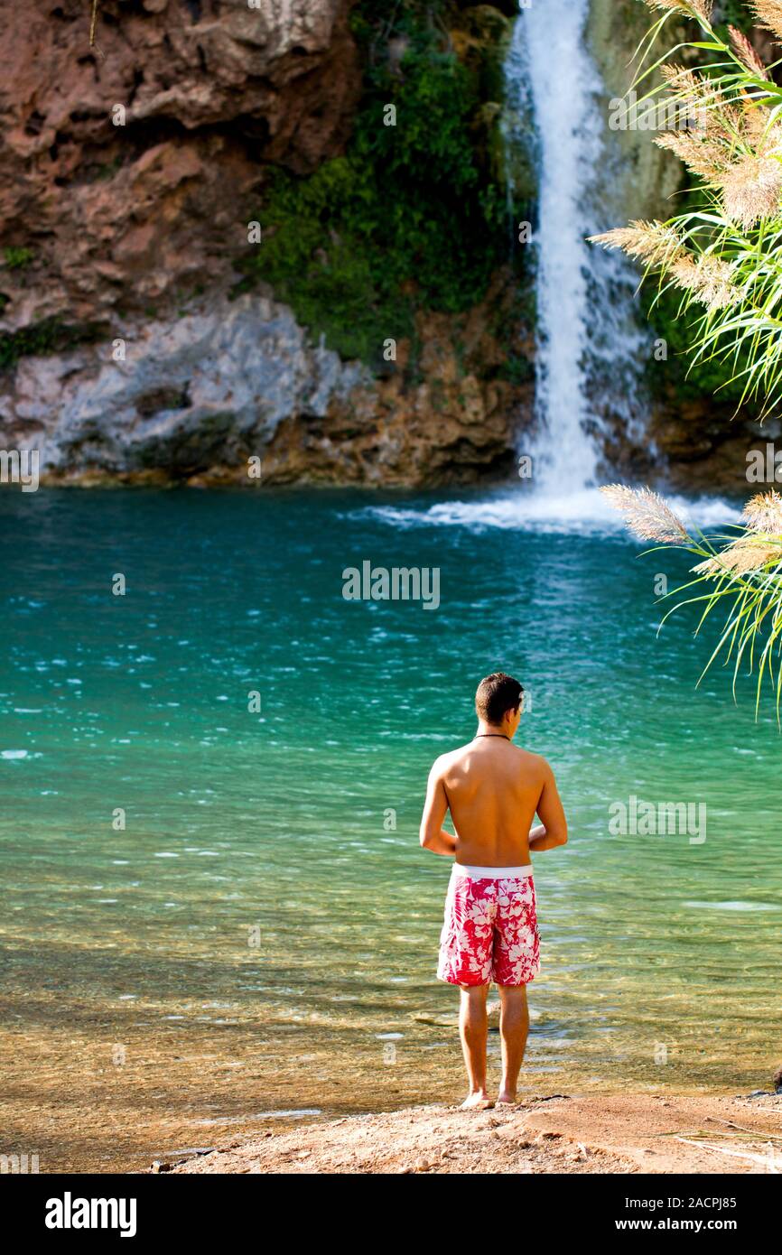 man and a beautiful waterfall Stock Photo - Alamy