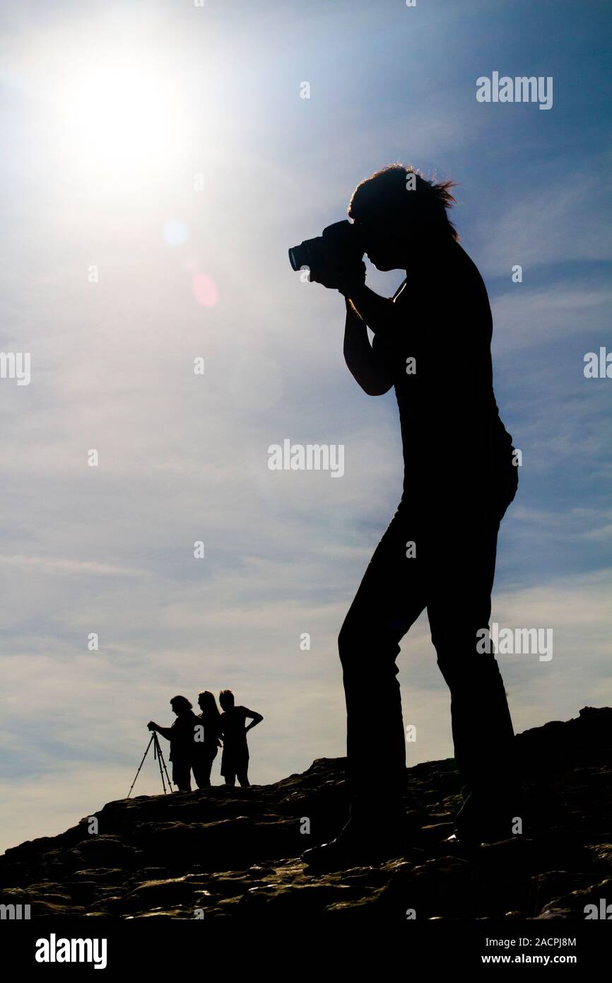 silhouettes taking photos Stock Photo - Alamy